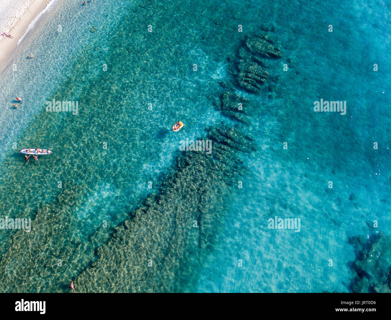 Aerial view of a canoe in the water floating on a transparent sea ...