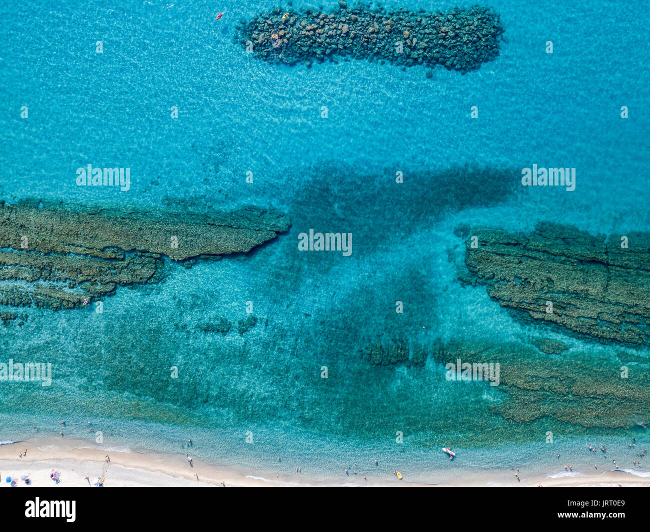Aerial view of a canoe in the water floating on a transparent sea ...