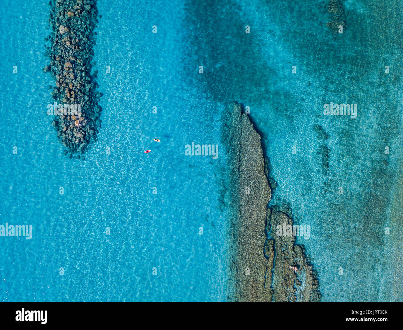 Aerial view of a canoe in the water floating on a transparent sea ...