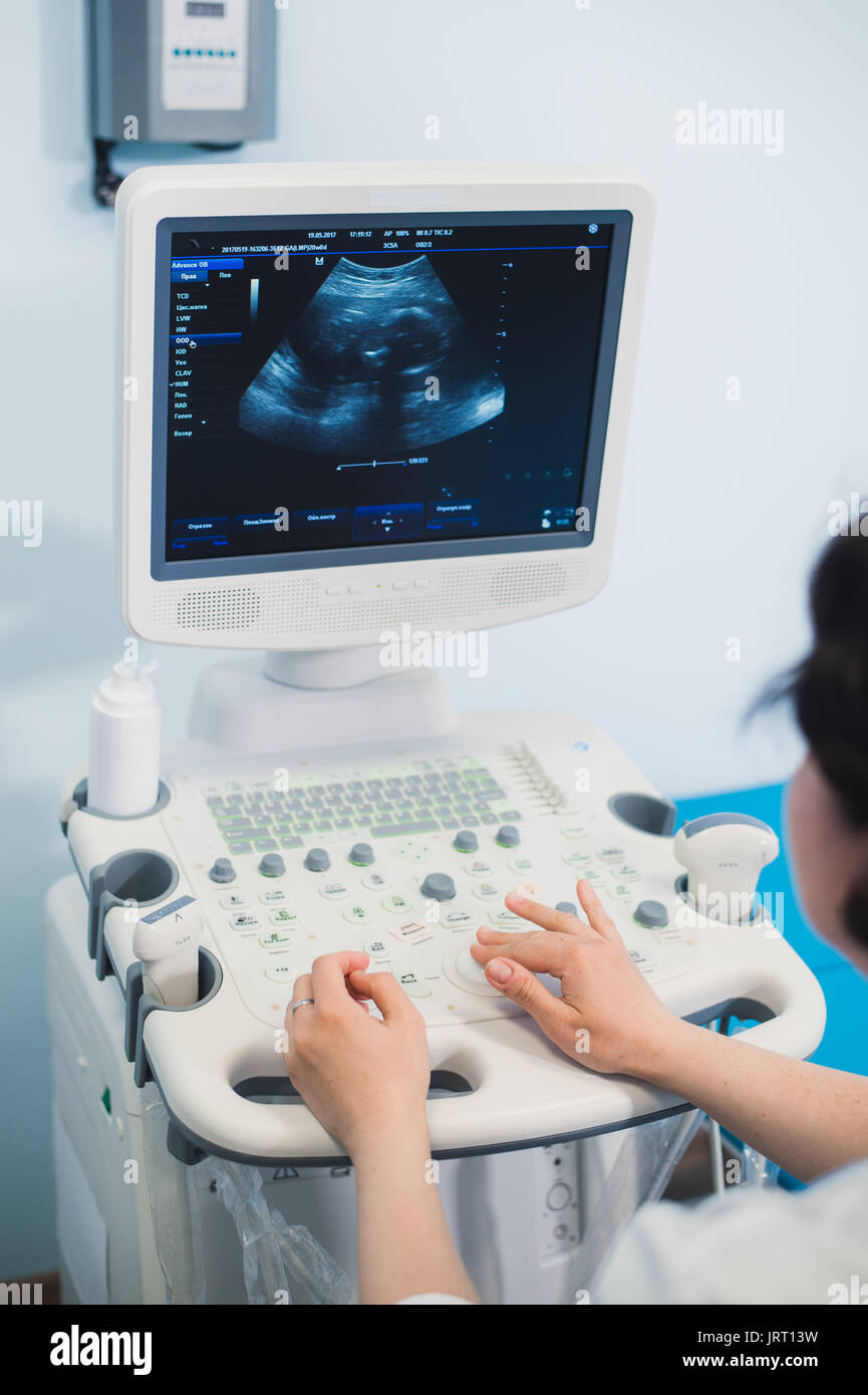 Skillful sonographer using ultrasound machine at work Stock Photo - Alamy
