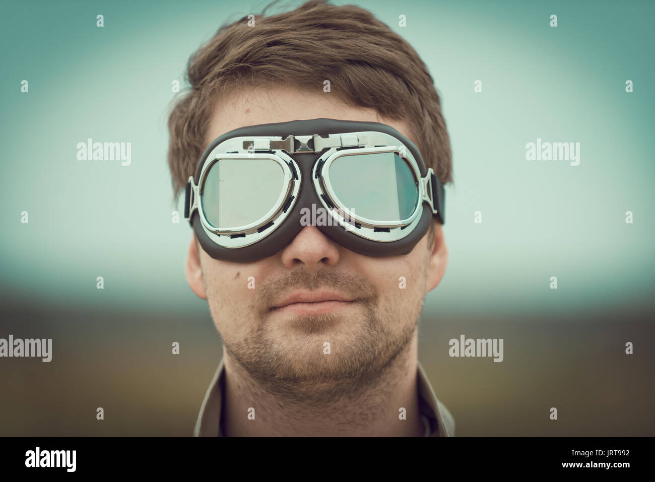 Young man wearing aviator goggles Stock Photo - Alamy