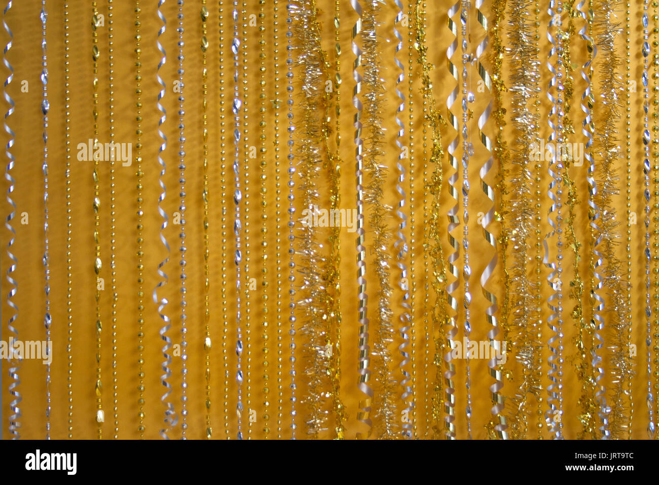 Strings of sparkly gold and silver form a background Stock Photo - Alamy