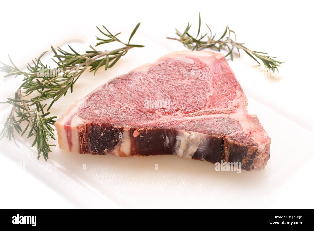 Raw dry aged steak with beef bones Stock Photo - Alamy