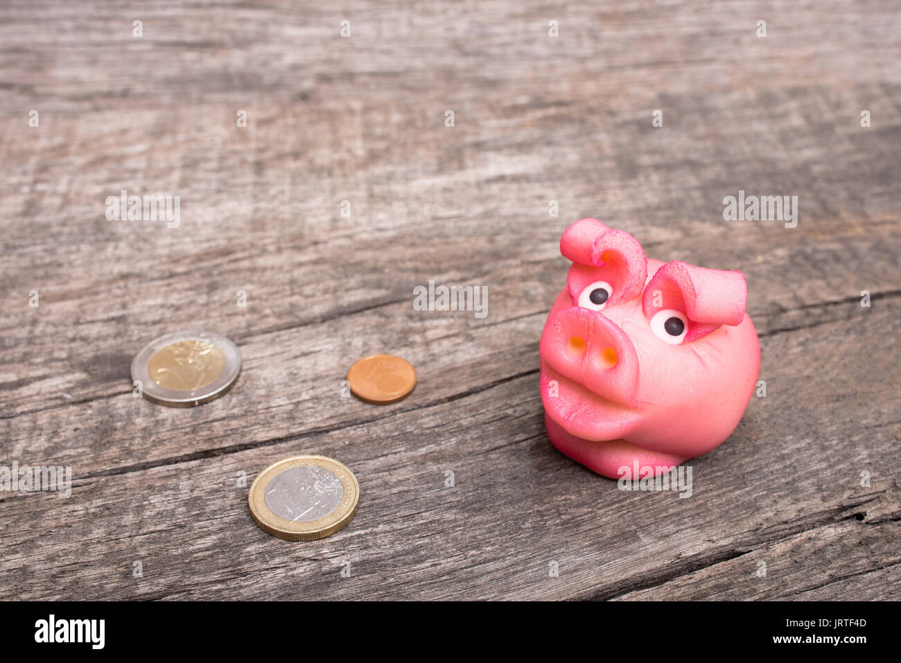 Luck pig of marzipan with coins for prosperity Stock Photo - Alamy