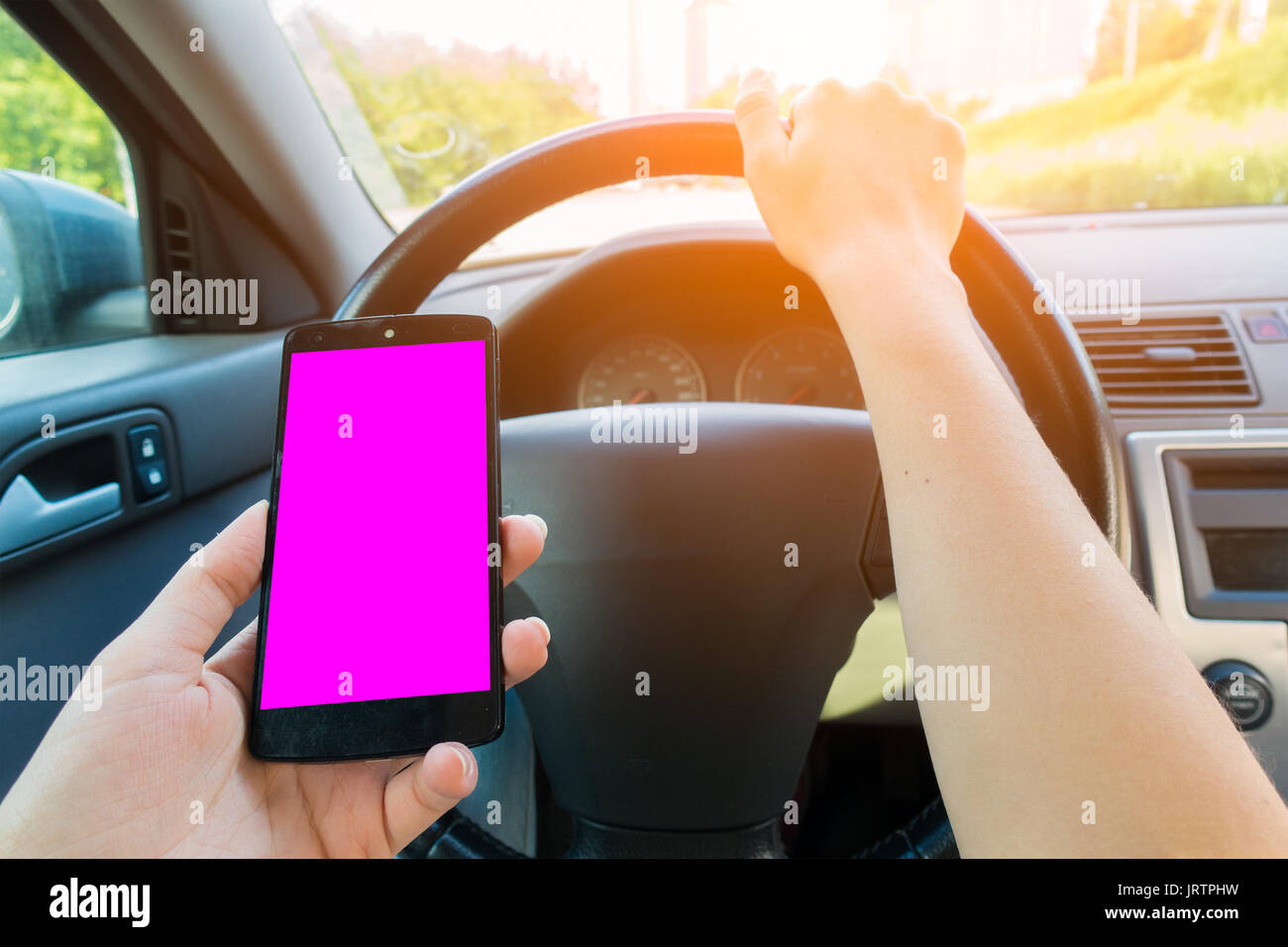 Woman holding smartphone in car Stock Photo - Alamy