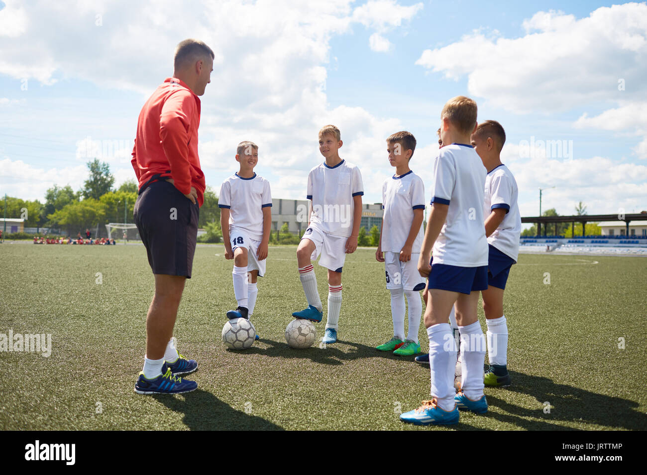 Junior Football Team Listening to Coach Stock Photo - Alamy