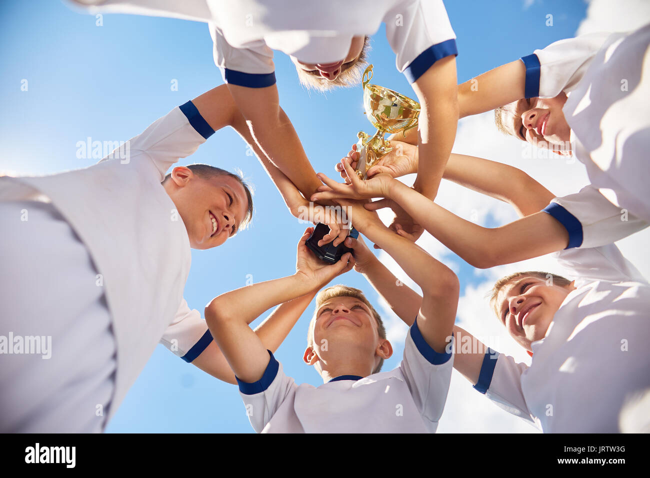 Kids with football trophy hi-res stock photography and images - Alamy