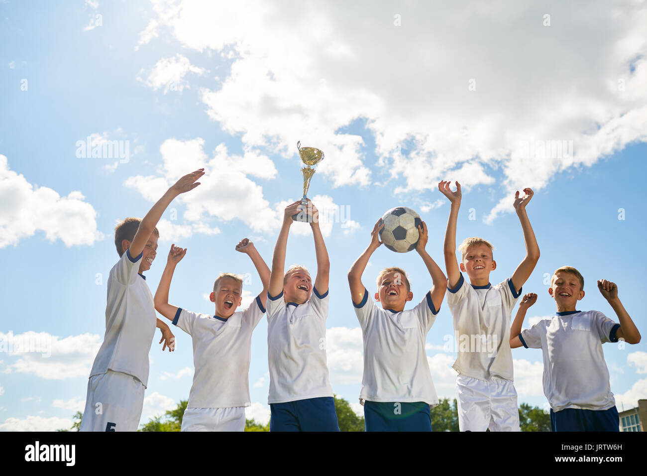 Boys soccer team celebrating trophy hi-res stock photography and images ...