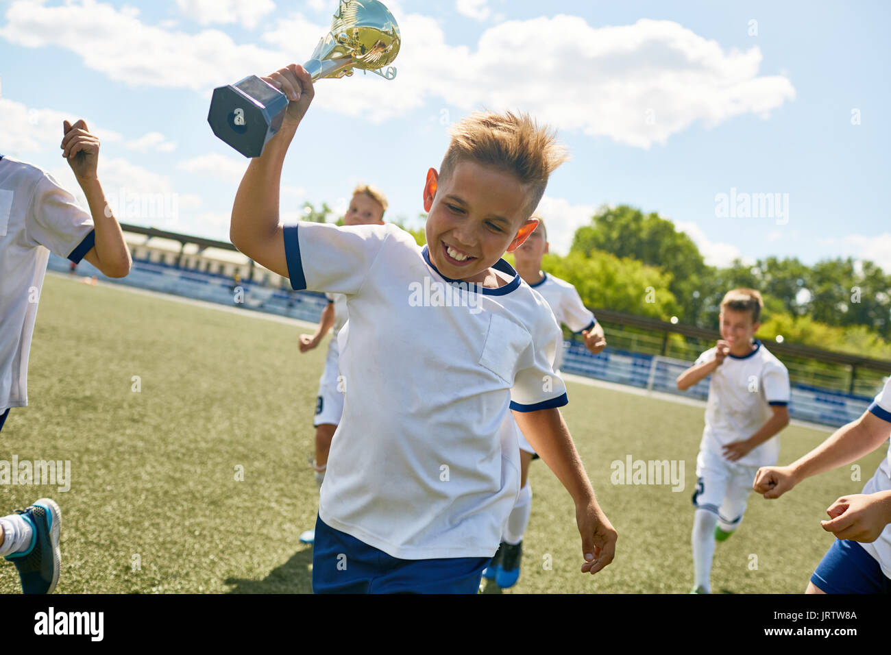 Children team trophy hi-res stock photography and images - Alamy