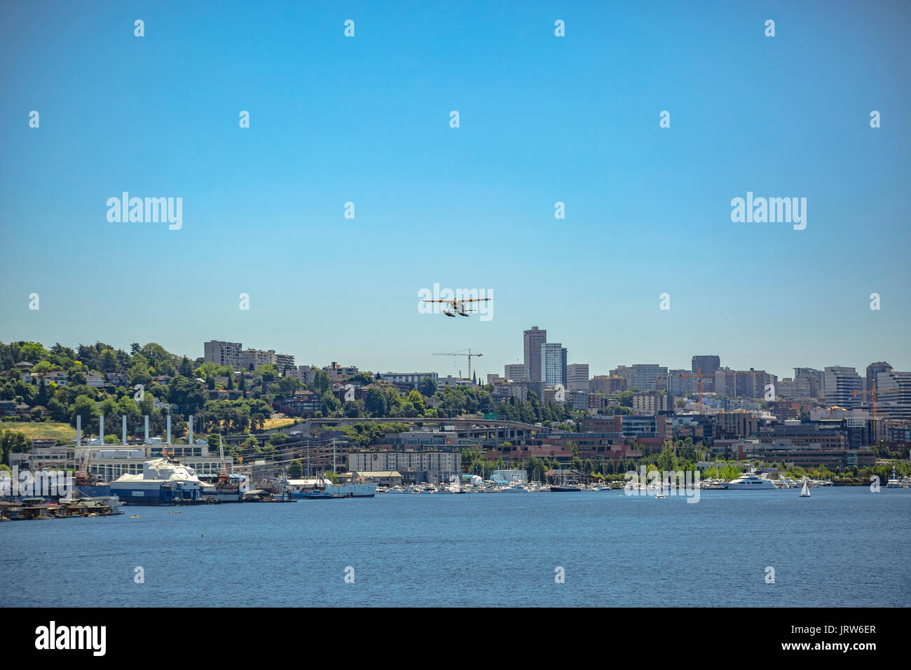 Float plane taking off above the buildings. Float plane taking off from ...