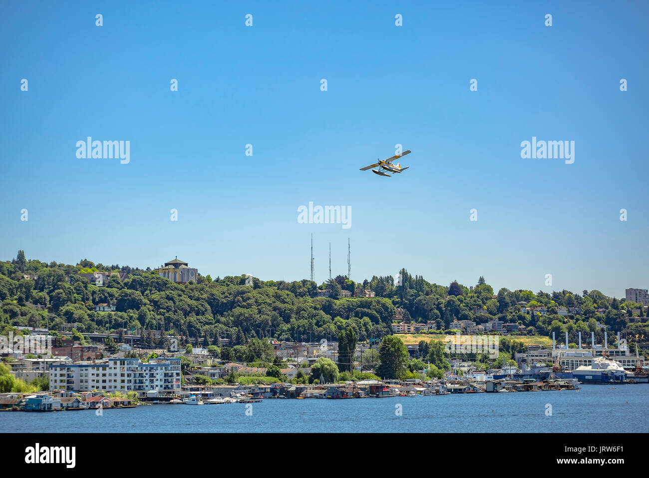 Float plane taking off in Seattle over trees. Float plane taking off ...