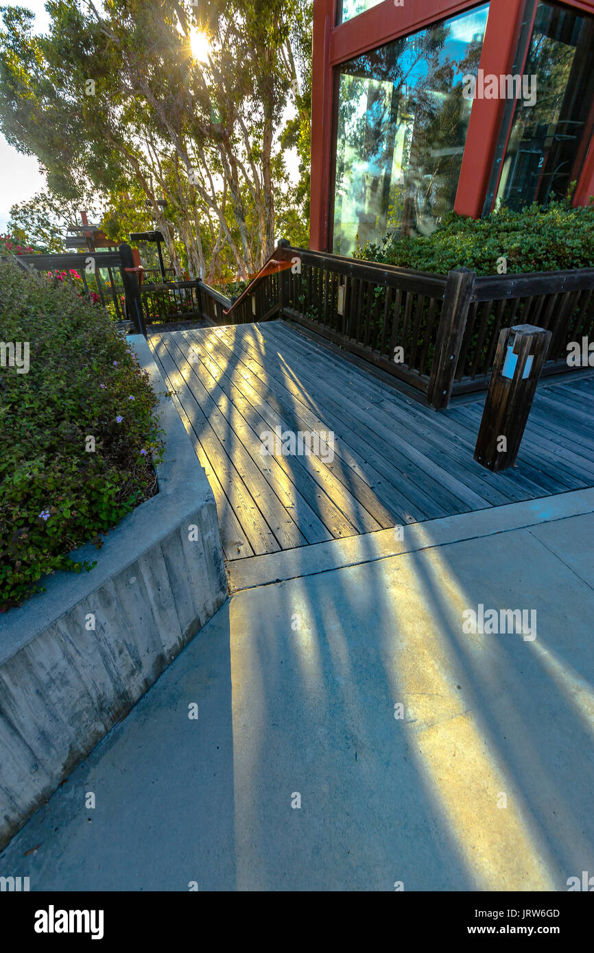 Light beams spilling onto the floor outside a modern building. Golden ...
