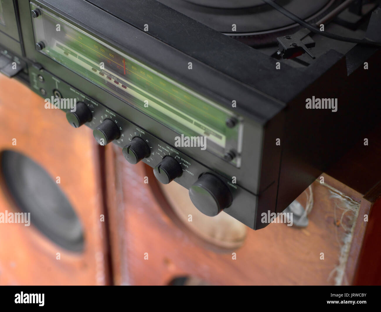 Old stereo system with a turntable on the top of loudspeakers, angled ...