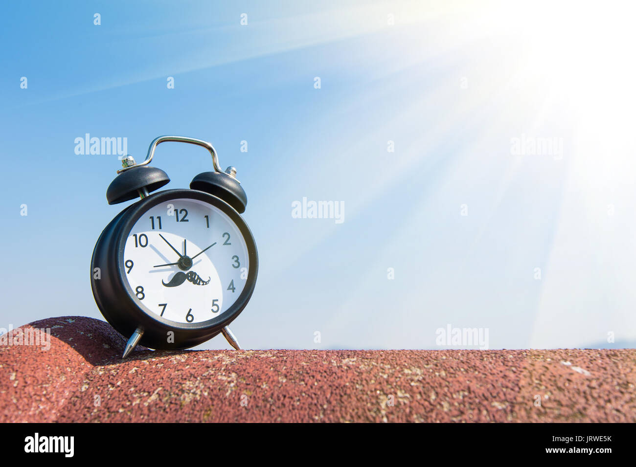 Alarm clock and sun light Stock Photo - Alamy