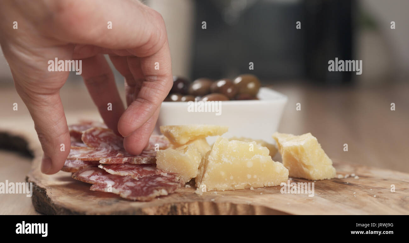 hands taking italian antipasti appetizers from table Stock Photo - Alamy