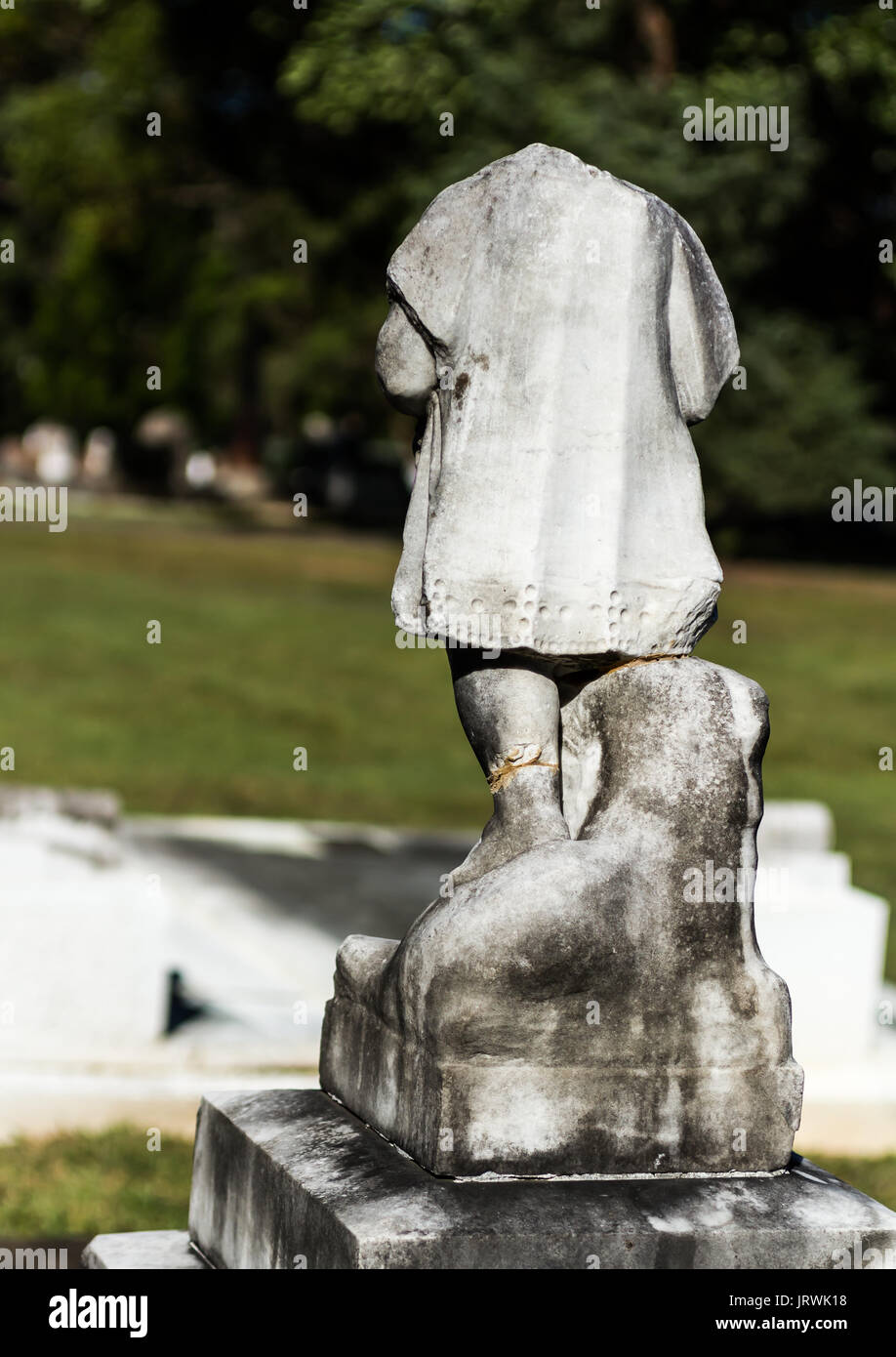 Rear view of a historic carving in a cemetery placed as a headstone on ...