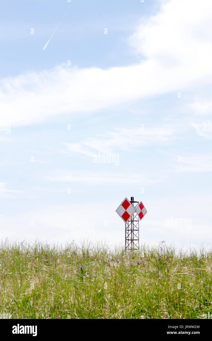 Day beacon in grassy sand dunes on a summer day in New England Stock ...