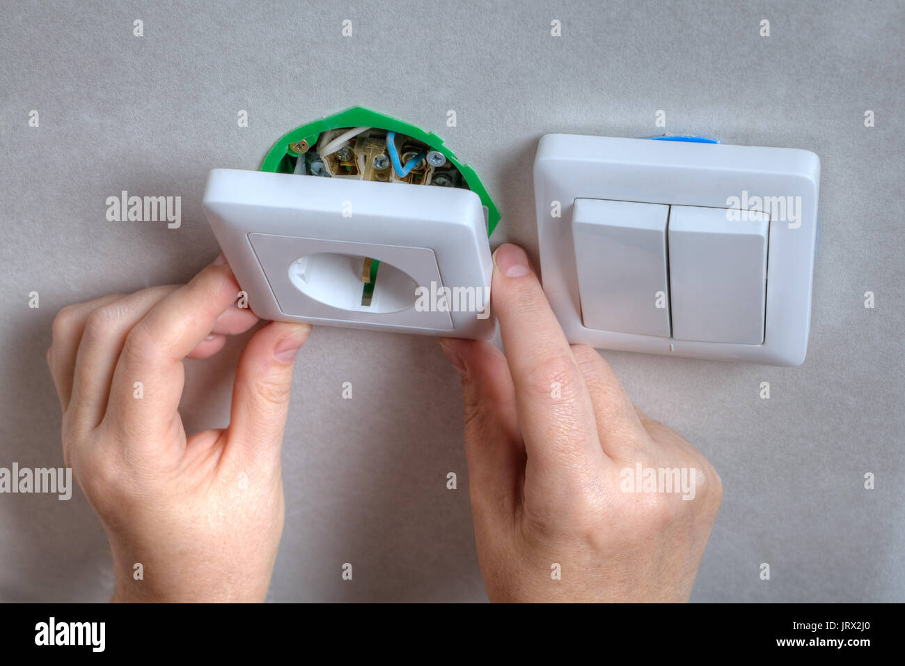 Fixing electrical wall outlet and light switch, electrician fitter ...