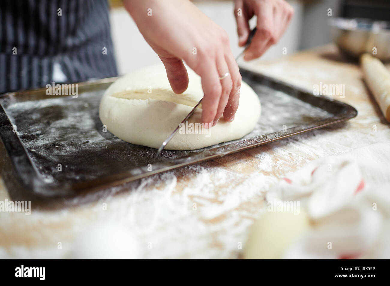 Hand cutting bread dough hi-res stock photography and images - Alamy