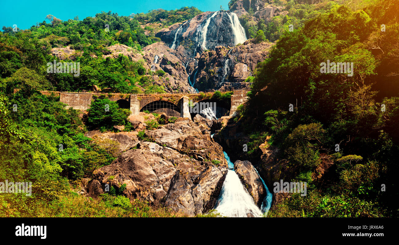 Morning, Panorama railway bridge in the mountains through the waterfall ...