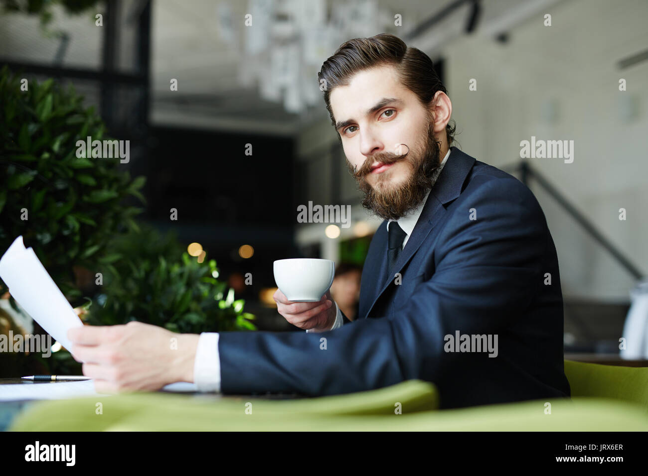 Reading in cafe Stock Photo - Alamy