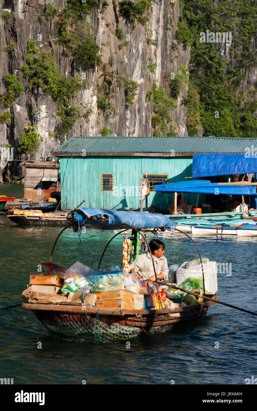 Boat woman vendor in Halong Bay, Vietnam. Drink snack hat vendor rowing ...