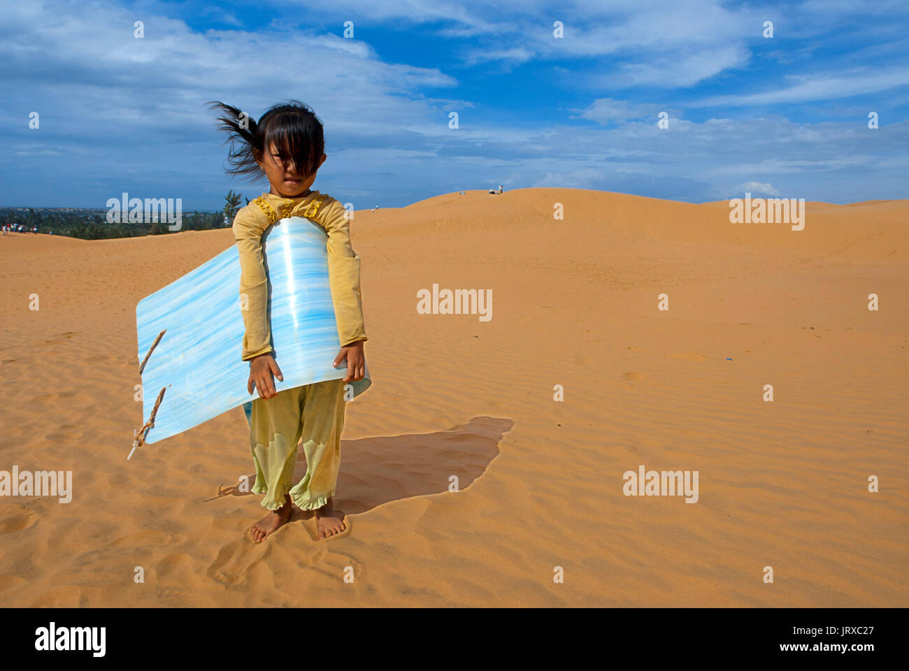 Mui Ne, Vietnam. Young girl with sand sled for hire at the White Sand ...