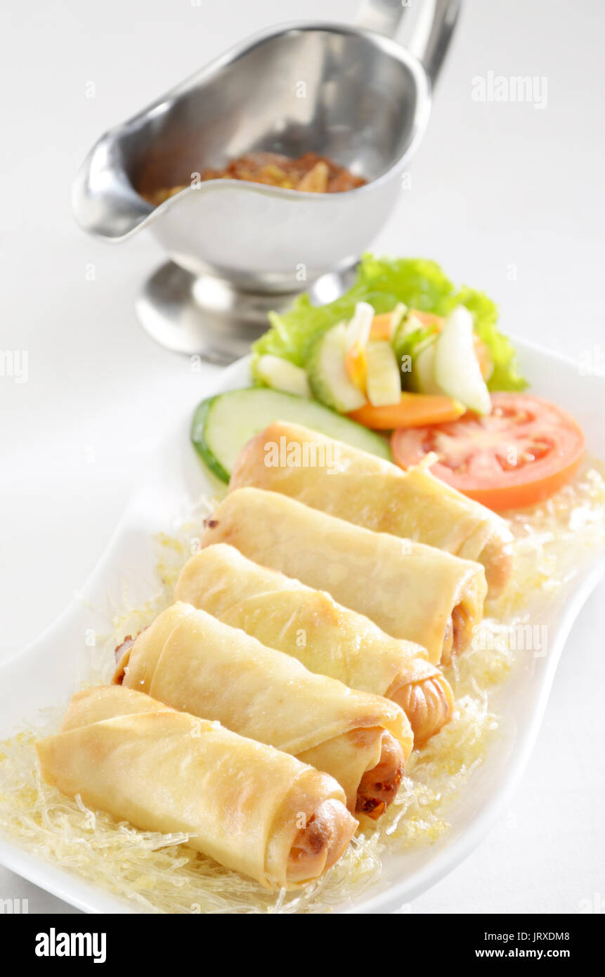 Indonesian Spring rolls served with garnish and sambal, chili paste ...