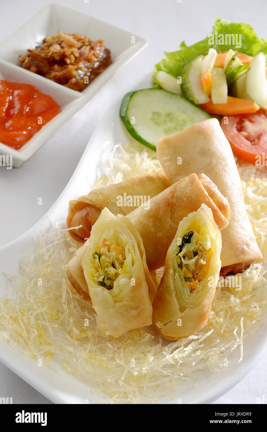 Indonesian Spring rolls served with garnish and sambal, chili paste ...