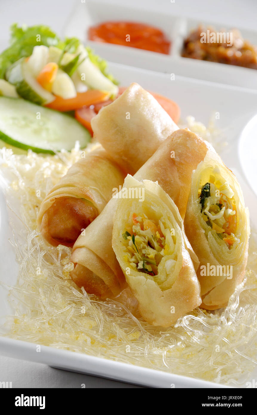 Indonesian Spring rolls served with garnish and sambal, chili paste ...