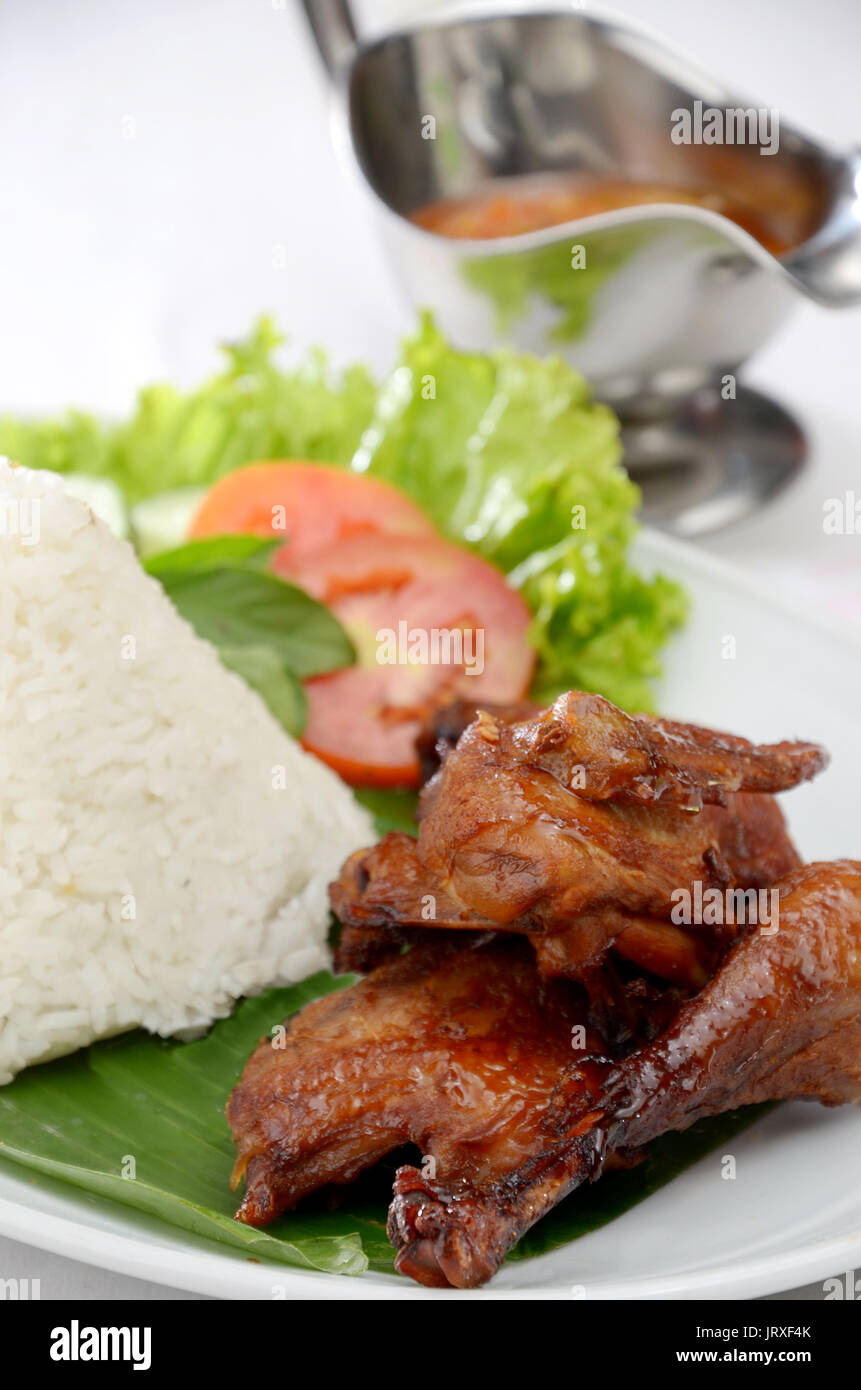 indonesian traditional grilled chicken serve with rice, vegetable ...