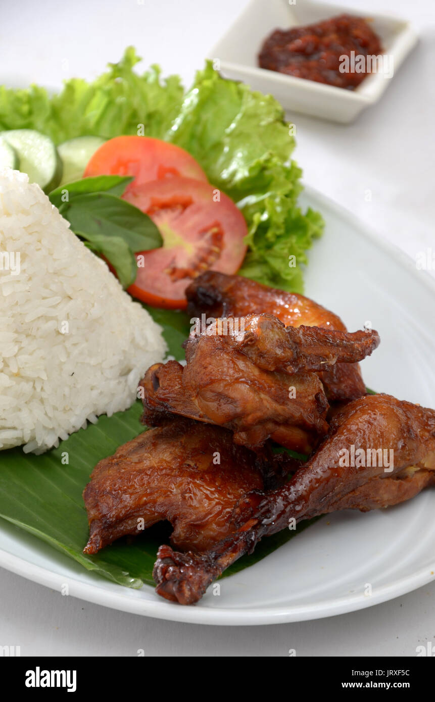 indonesian traditional grilled chicken serve with rice, vegetable ...