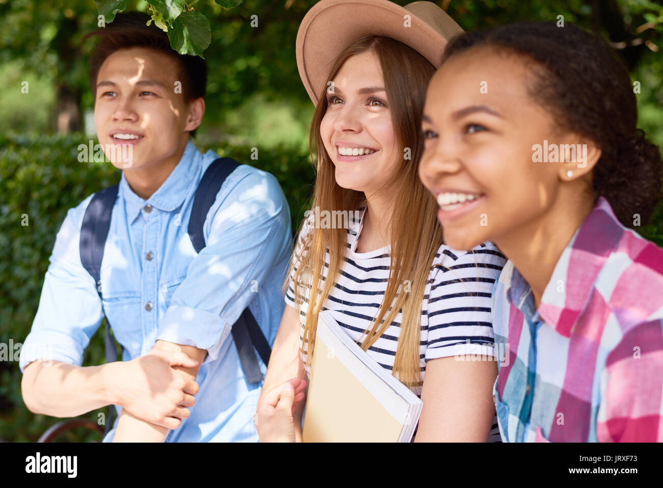 Three Students in Park Stock Photo - Alamy