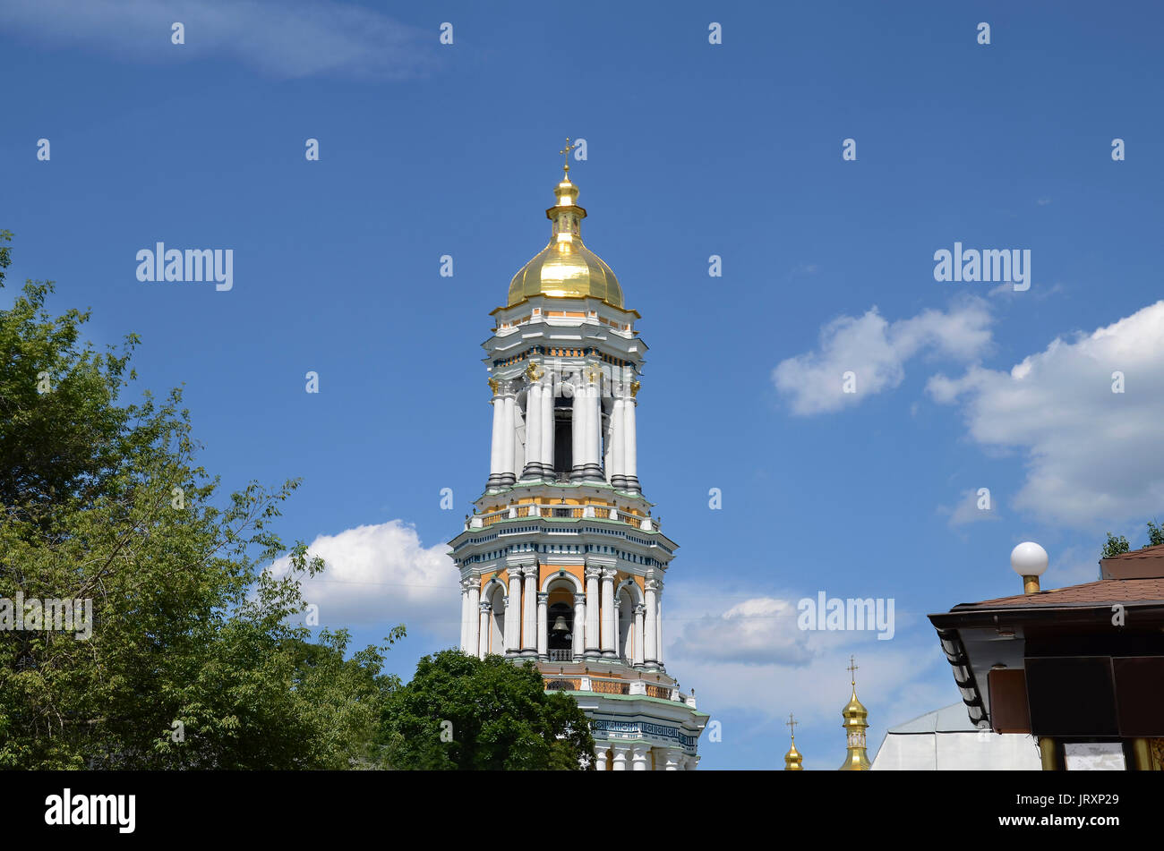 Beautiful bell tower with a golden dome and a cross, an Orthodox ...