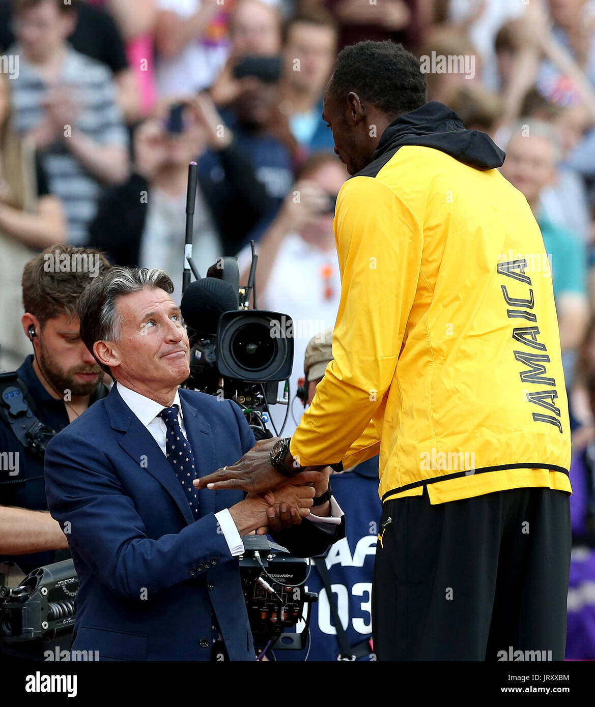 IAAF President Lord Sebastian Coe gives Jamaica's Usain Bolt the bronze ...
