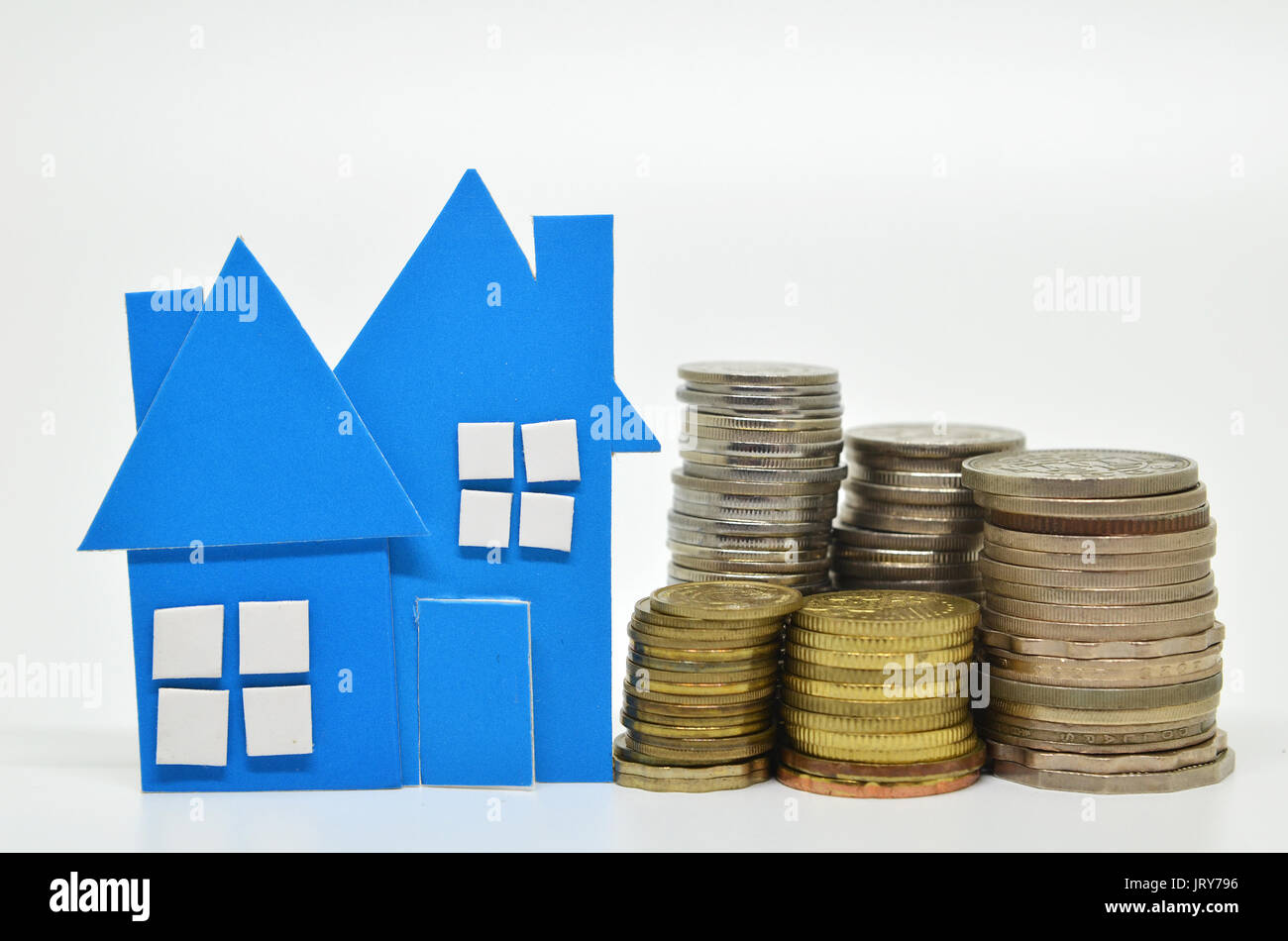 Blue paper house model and stacks of coins Stock Photo - Alamy