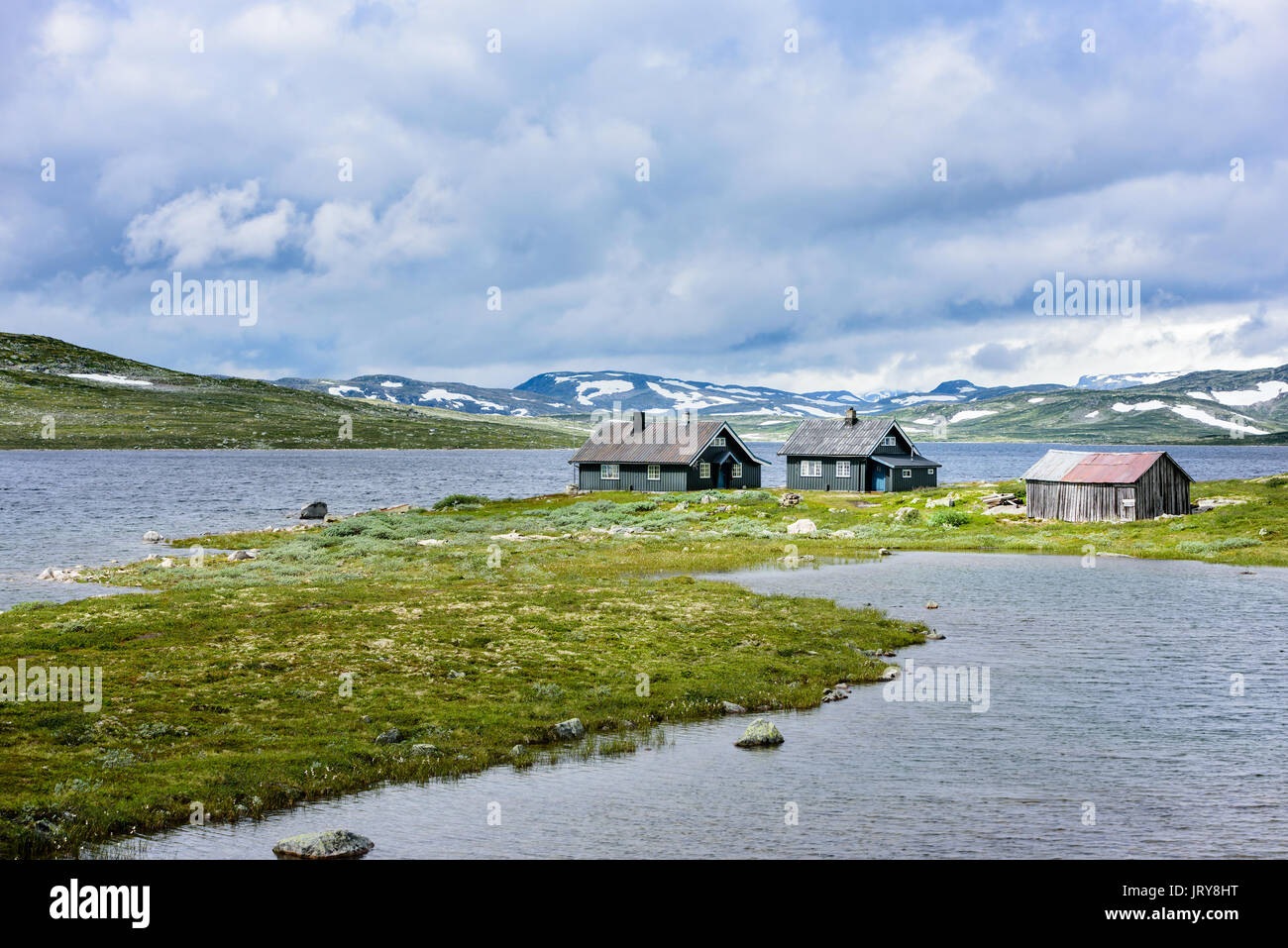 Mountain landscape at small lakeside village with two homes and a barn ...