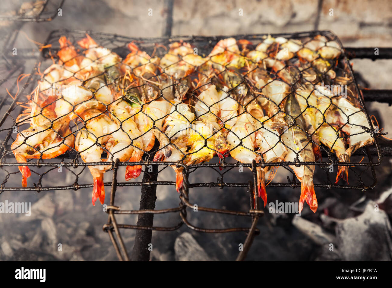 Grilled fresh seafood: parrot fish, octopus, shrimp food background ...