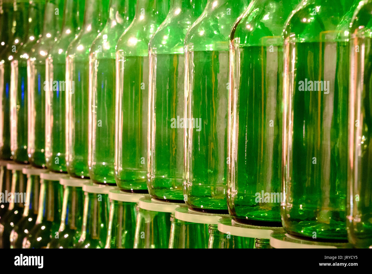 Rows of green glass bottles in "Glass: Shattering Notions" gallery in ...