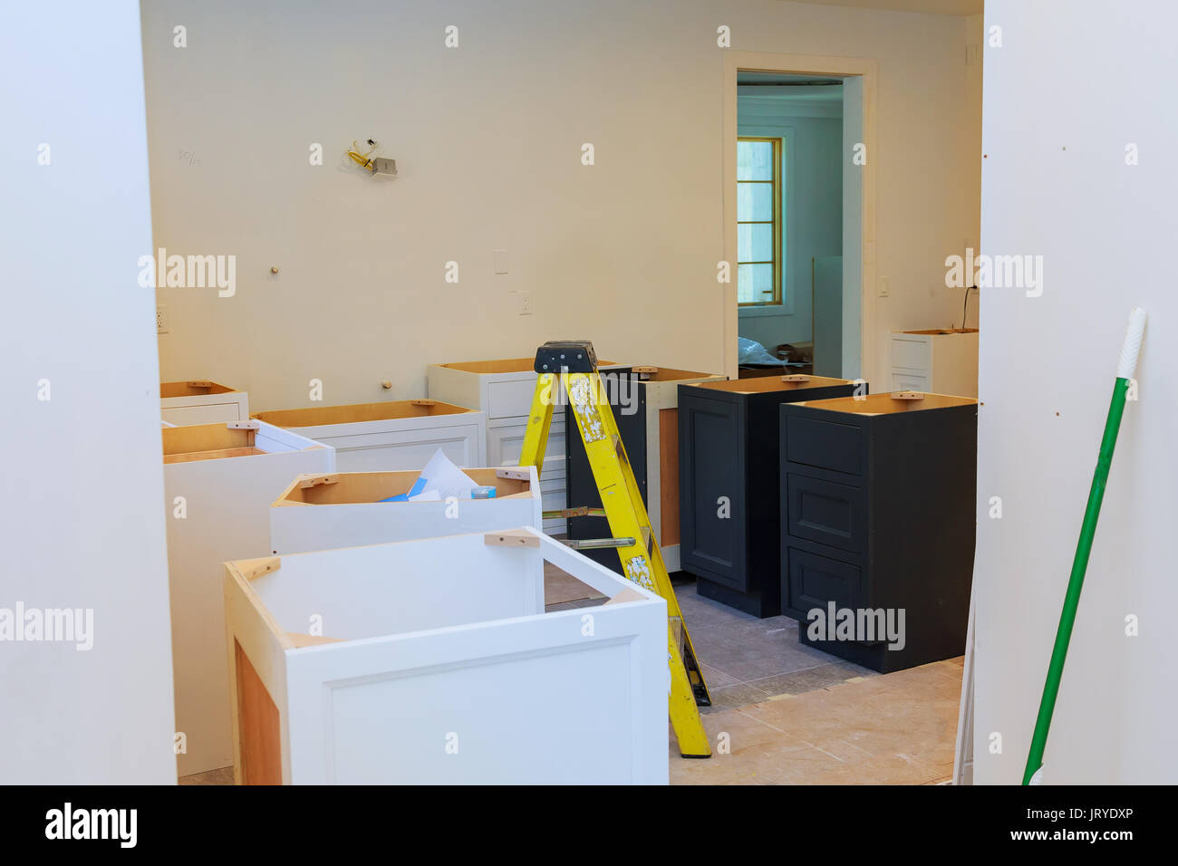 Custom kitchen cabinets in various stages of installation base for ...