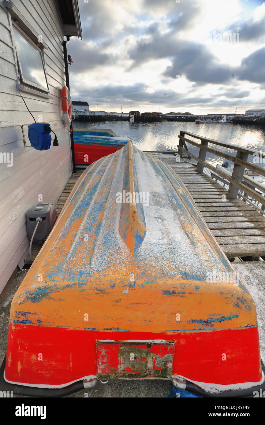 Small red-green fishing boats put ashore alongside white wooden ...