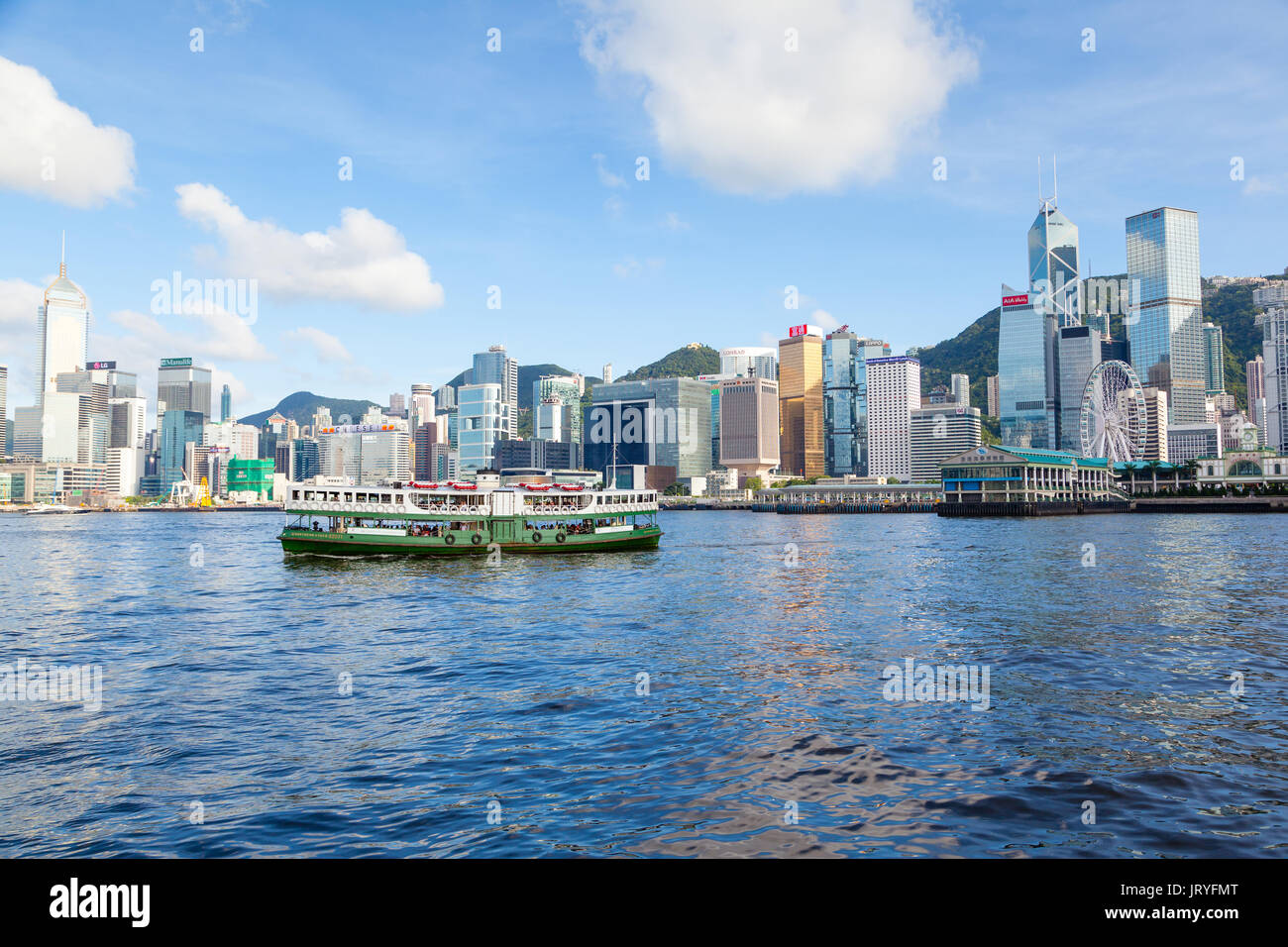 A ferry cruises Victoria harbour at Tsim Sha Tsui in Hong Kong, with the modern skyscrapers of ...