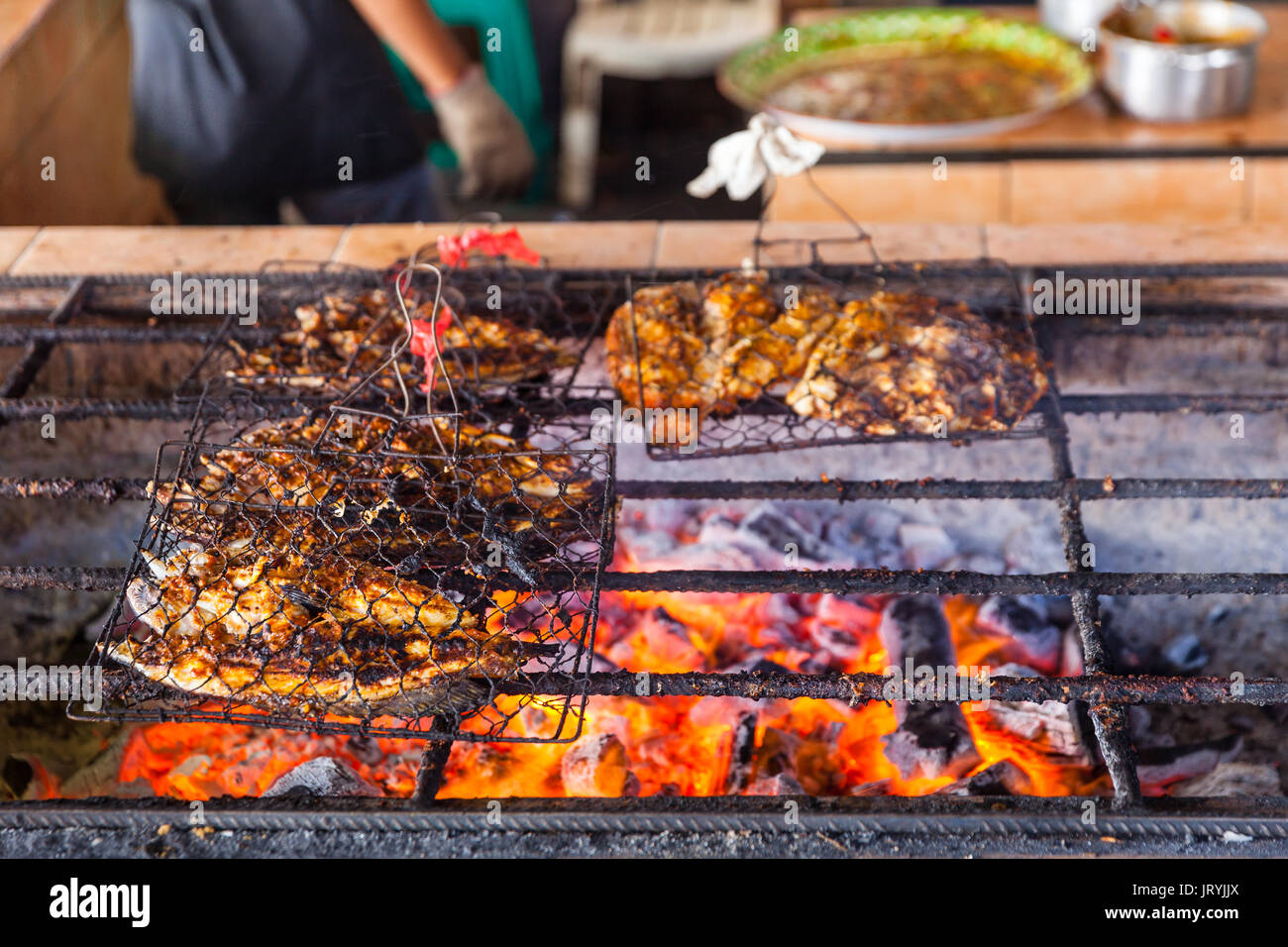 Grilled fresh seafood: parrot fish, octopus, shrimp food background ...