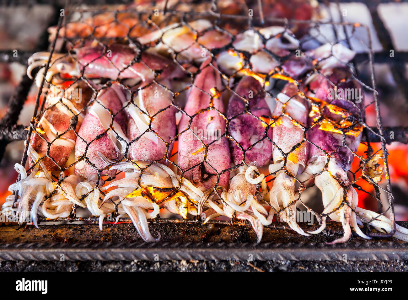 Grilled fresh seafood: parrot fish, octopus, shrimp food background ...