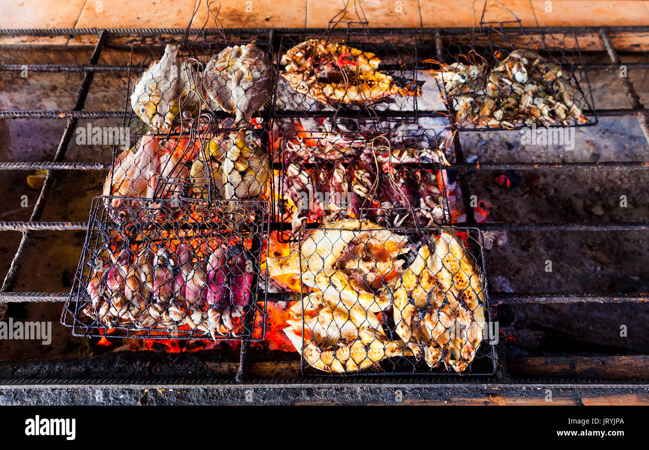 Grilled fresh seafood: parrot fish, octopus, shrimp food background ...