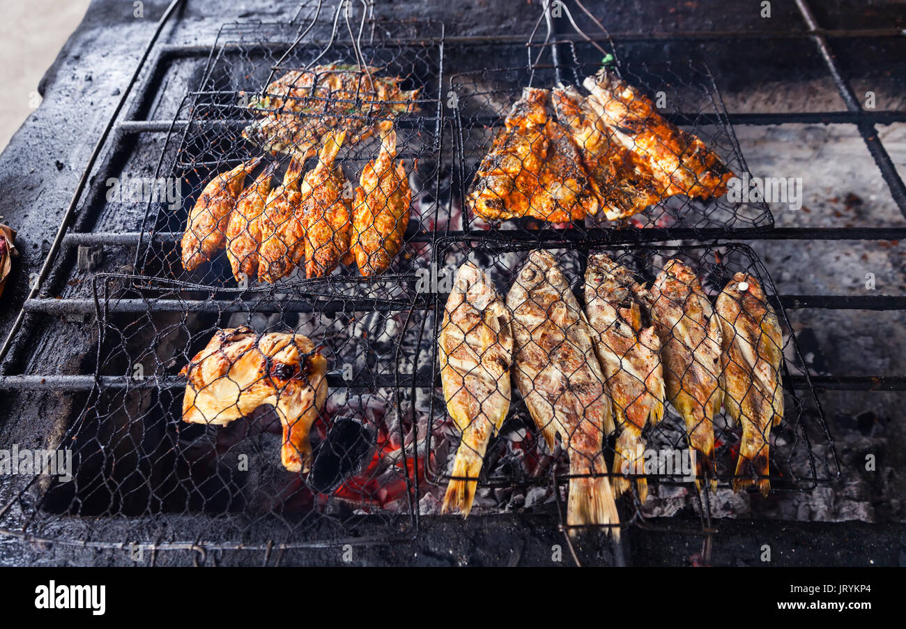 Grilled fresh seafood: parrot fish, octopus, shrimp food background ...