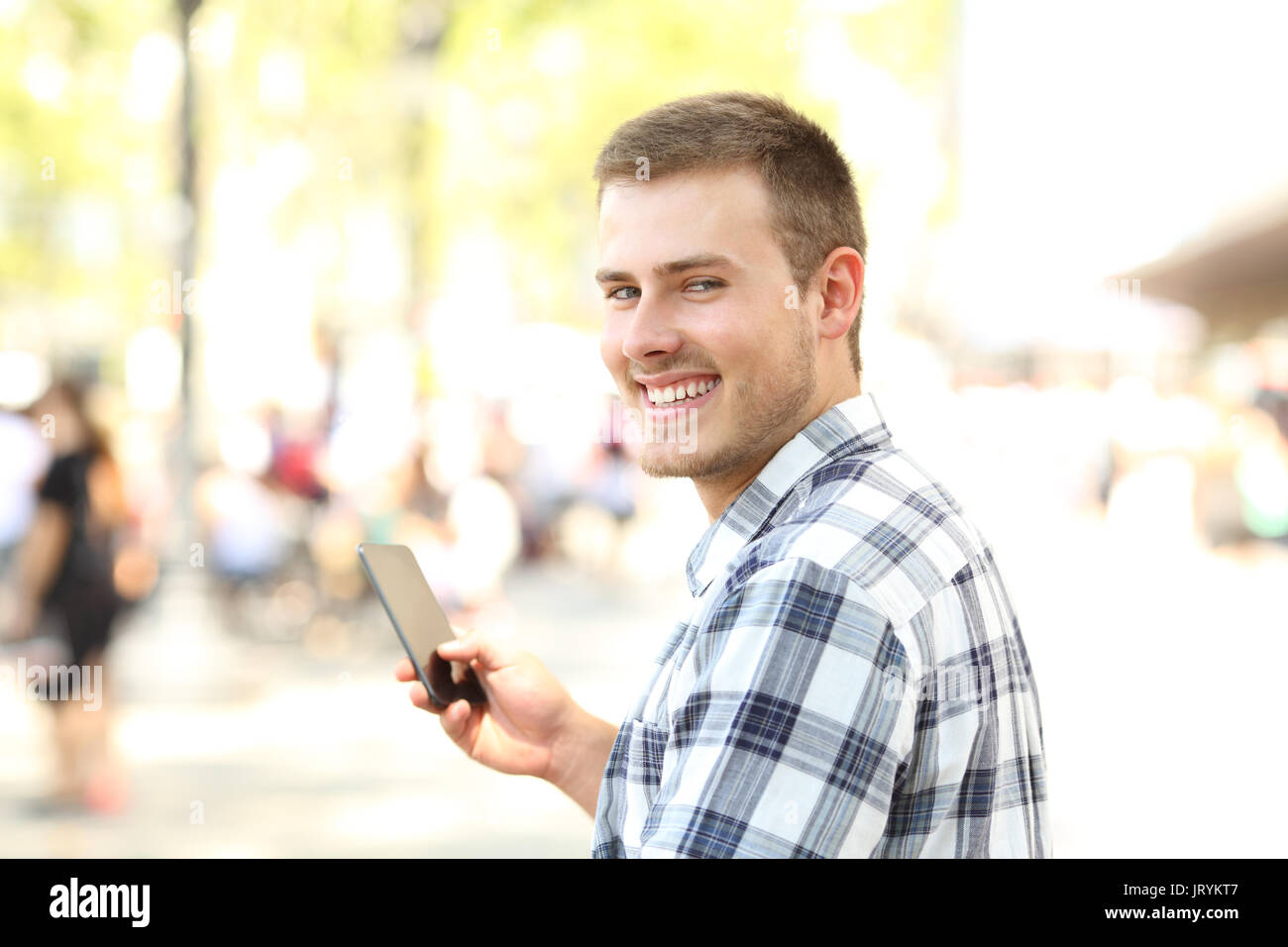 Man walking looking phone hi-res stock photography and images - Alamy