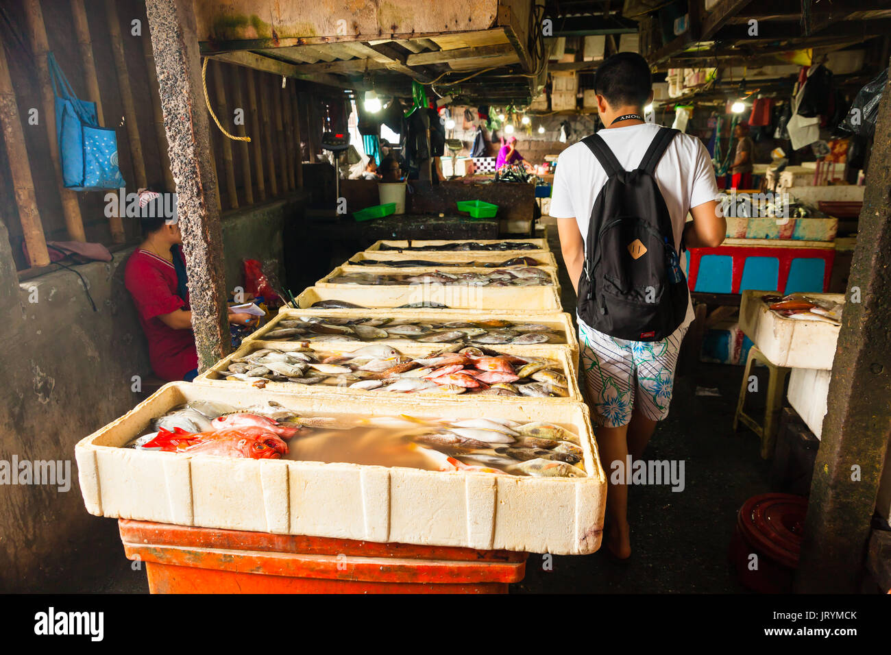 Silhouette of a male backpacker traveler choosing fresh sea food in the ...