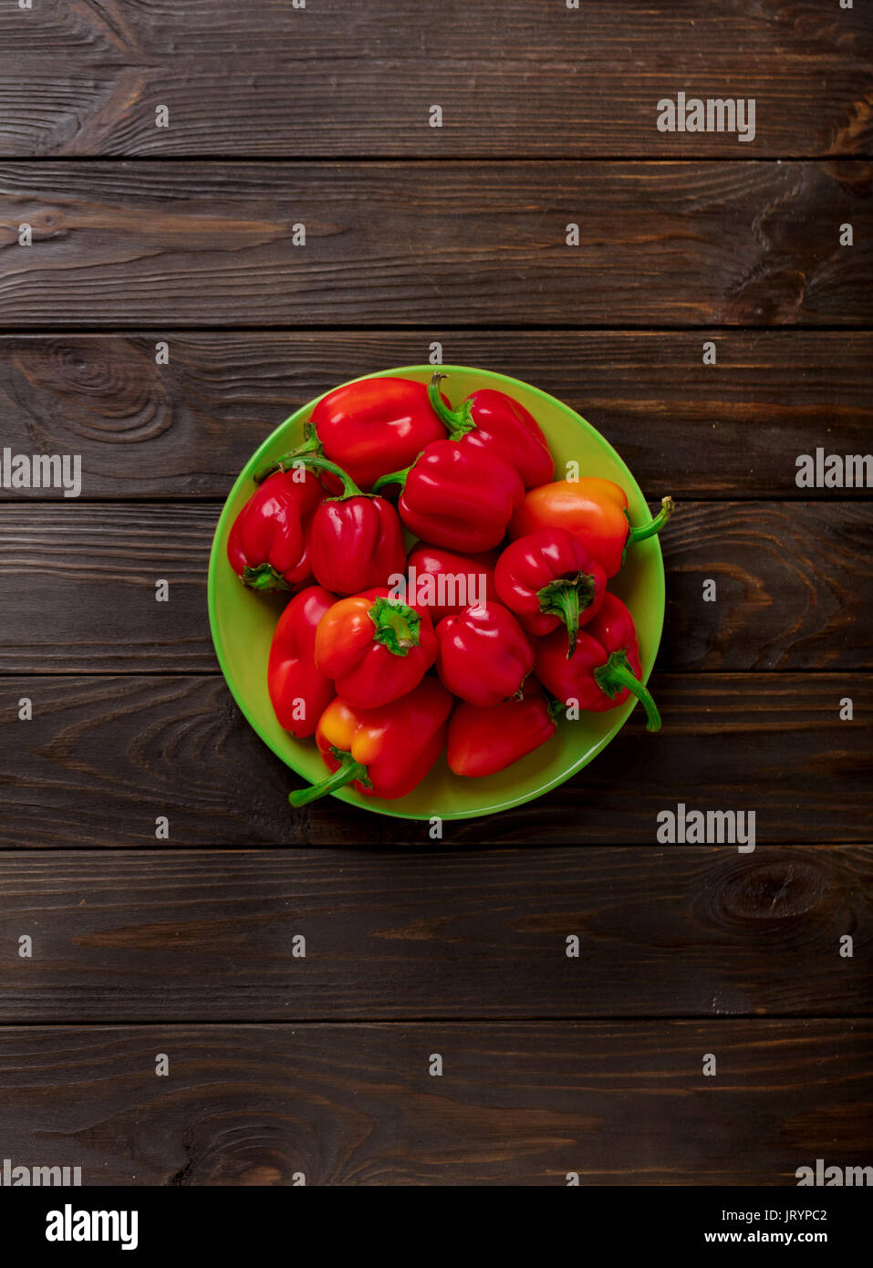Sweet bulgarian red peppers on a dark wooden background. Selective ...