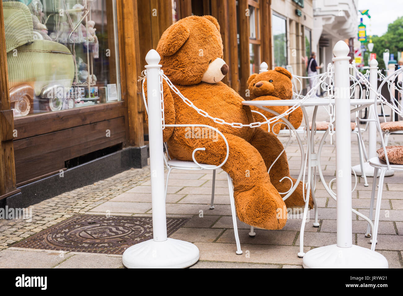 Teddy Bear sitting on a chair in street cafe Stock Photo - Alamy